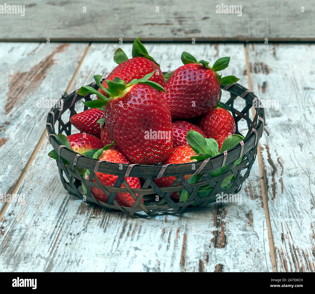 Strawberries surrounded by rustic background Stock Photo - Alamy