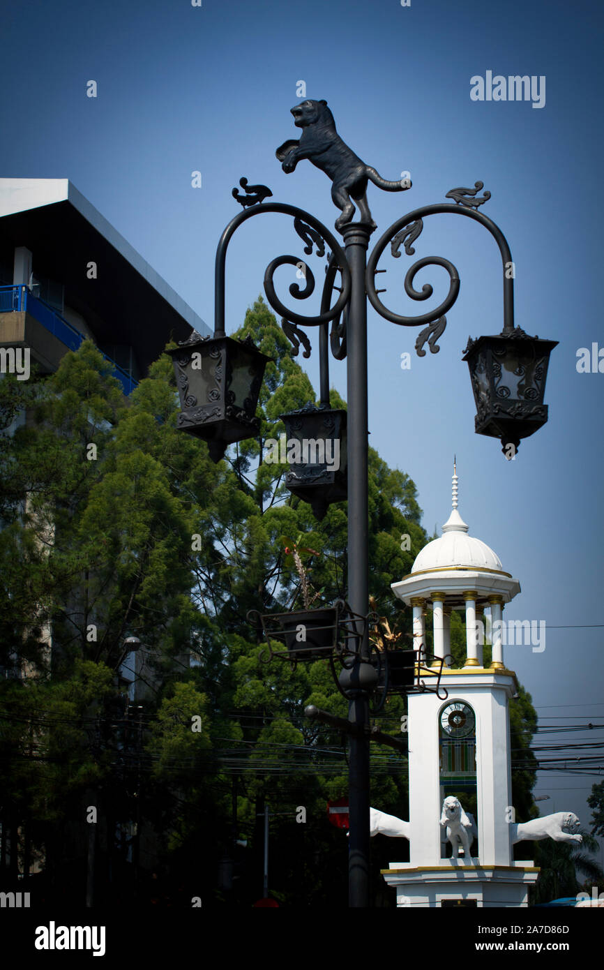 Unique town street light near a monument at the intersection Stock ...
