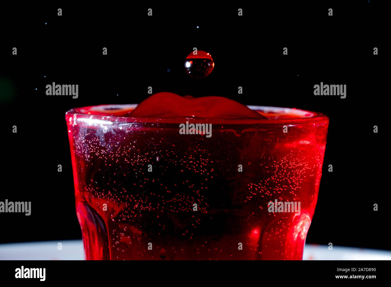 drops of red liquid in glass beaker Stock Photo - Alamy