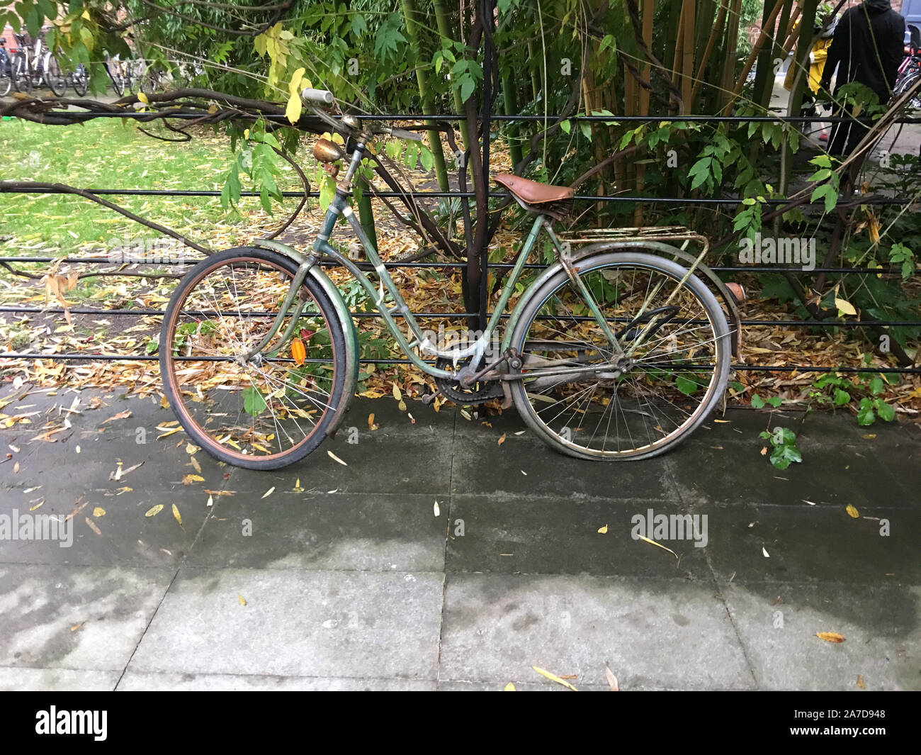 A retro styled bicycle placed against some metal railing in Malmö ...