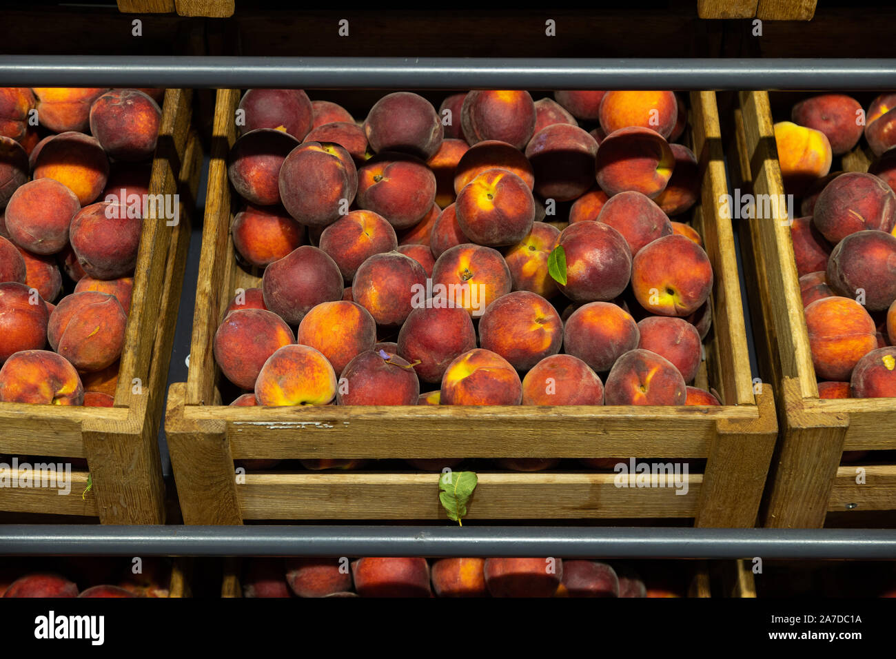 Wooden lug box with soft and mellow peaches on counter Stock Photo - Alamy