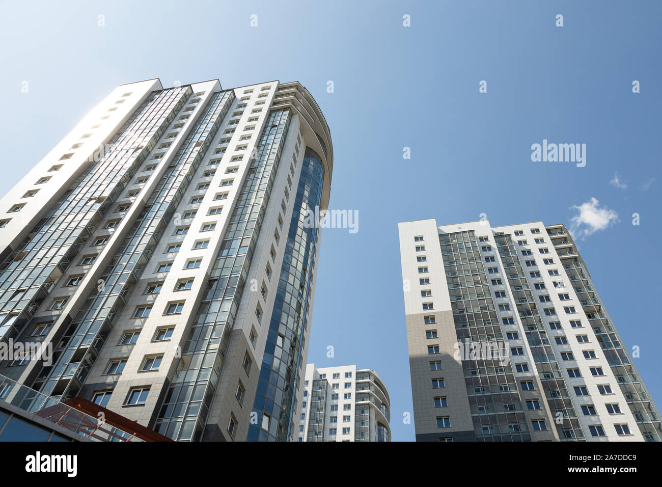 ground diagonal view of high modern luxury tiled apartment building on ...