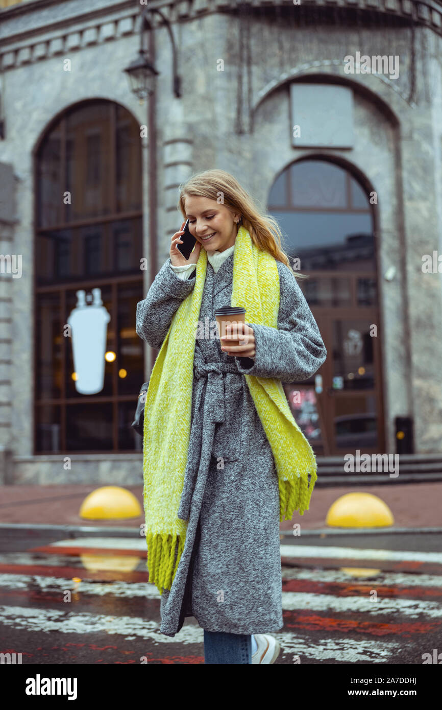 Female using her mobile phone at the pedestrian crossing Stock Photo ...