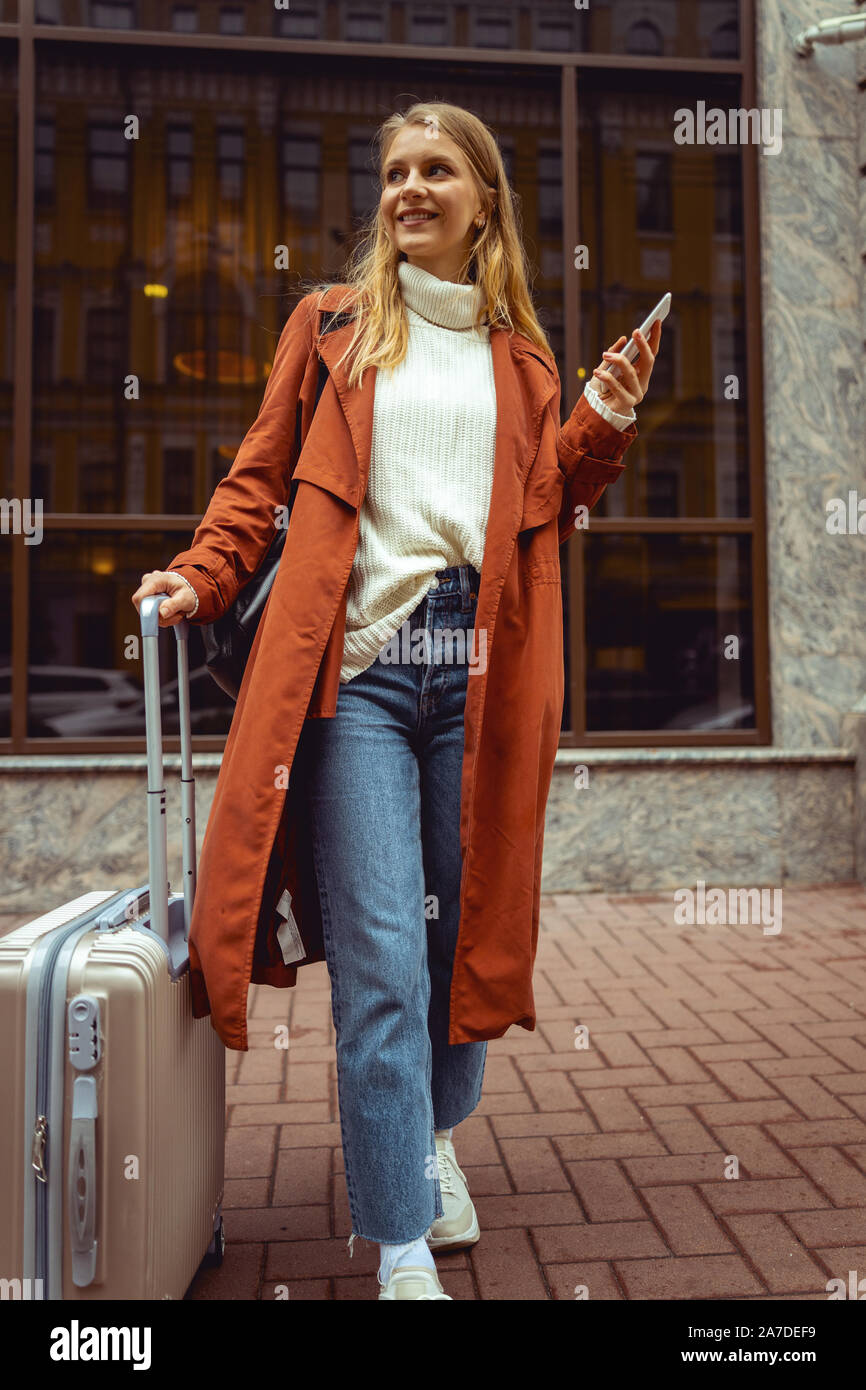Contented woman standing in front of the building Stock Photo - Alamy