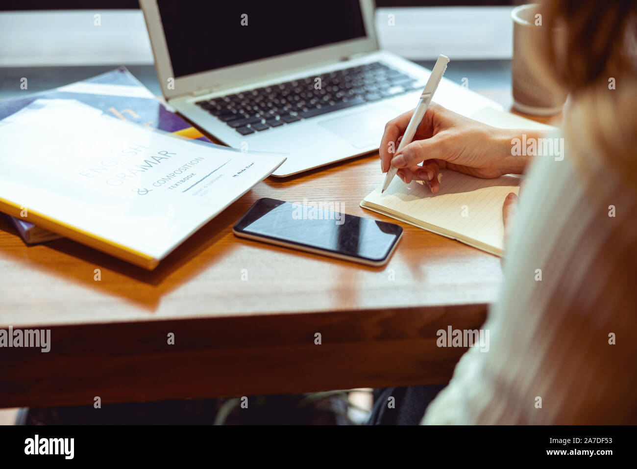 Caucasian student girl doing grammar exercises indoors Stock Photo - Alamy