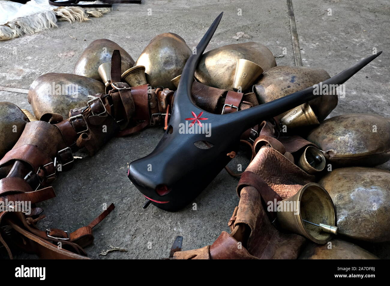 Cowbells and "su boe" mask on the floor before the parade. Ottana ...