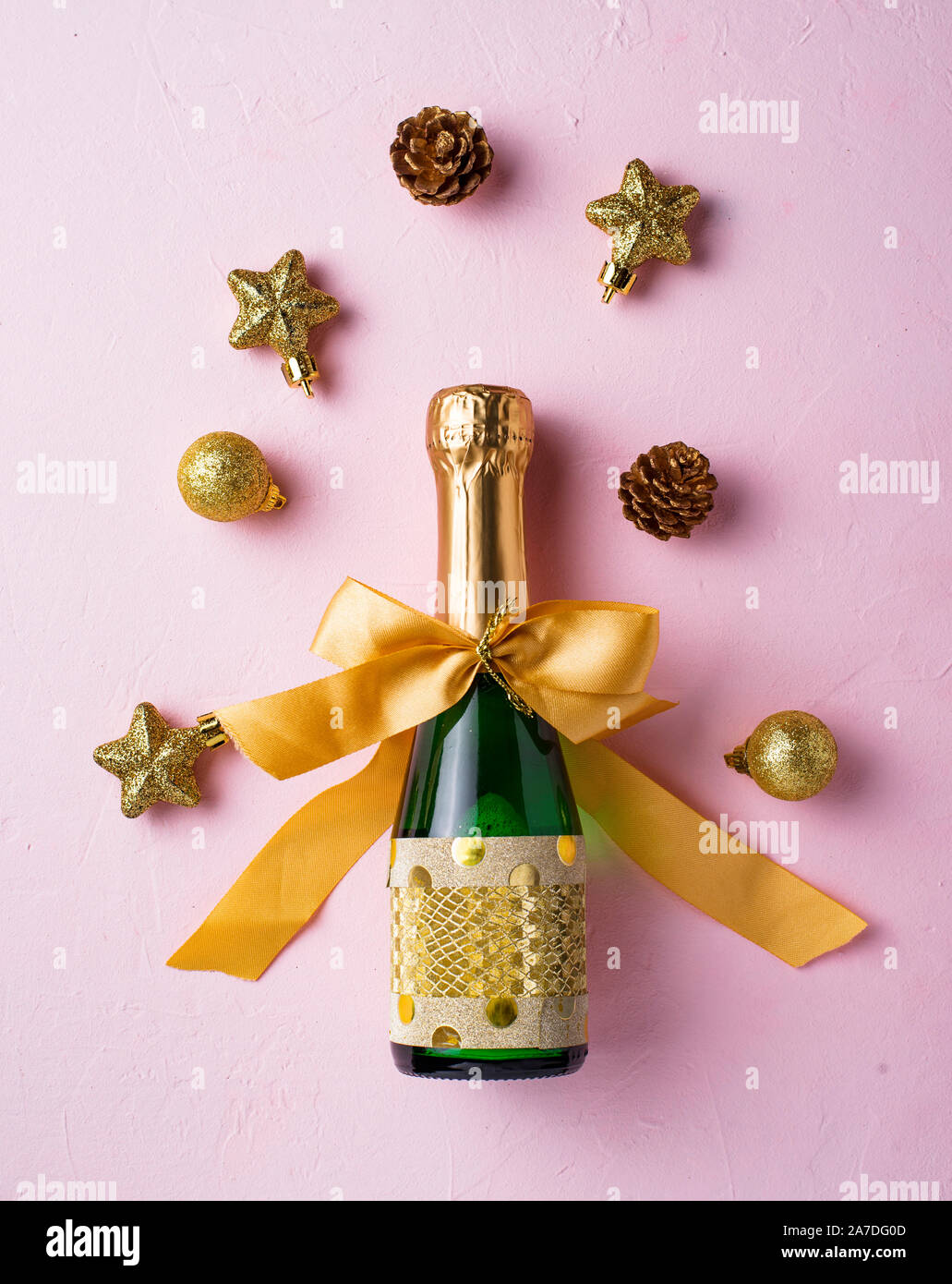 Bottle of champagne in a gold wrapper Stock Photo - Alamy