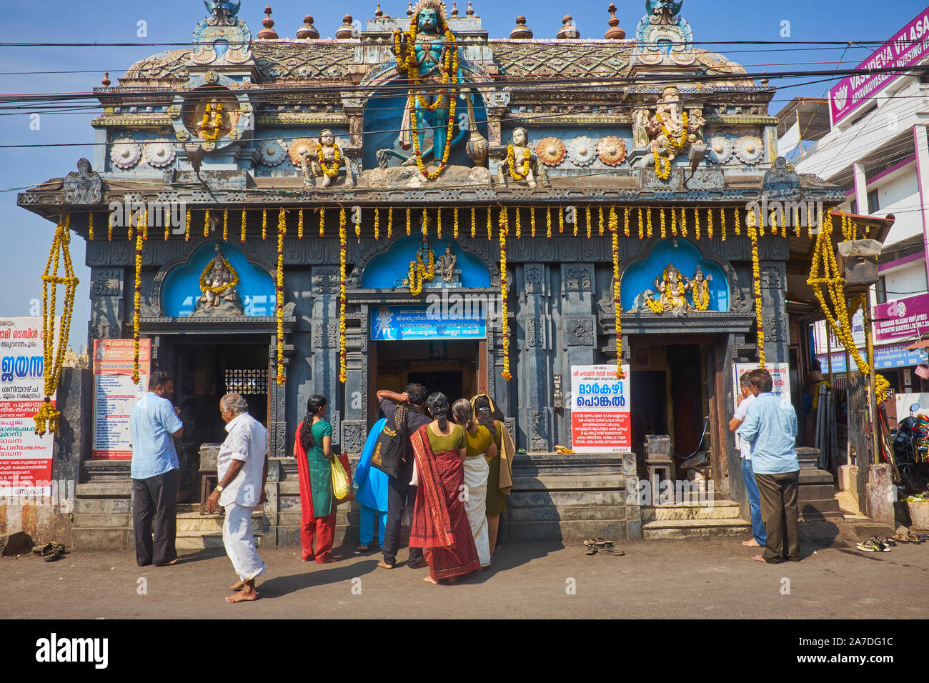 Visitors at a small, ornate Hindu temple in Trivandrum ...