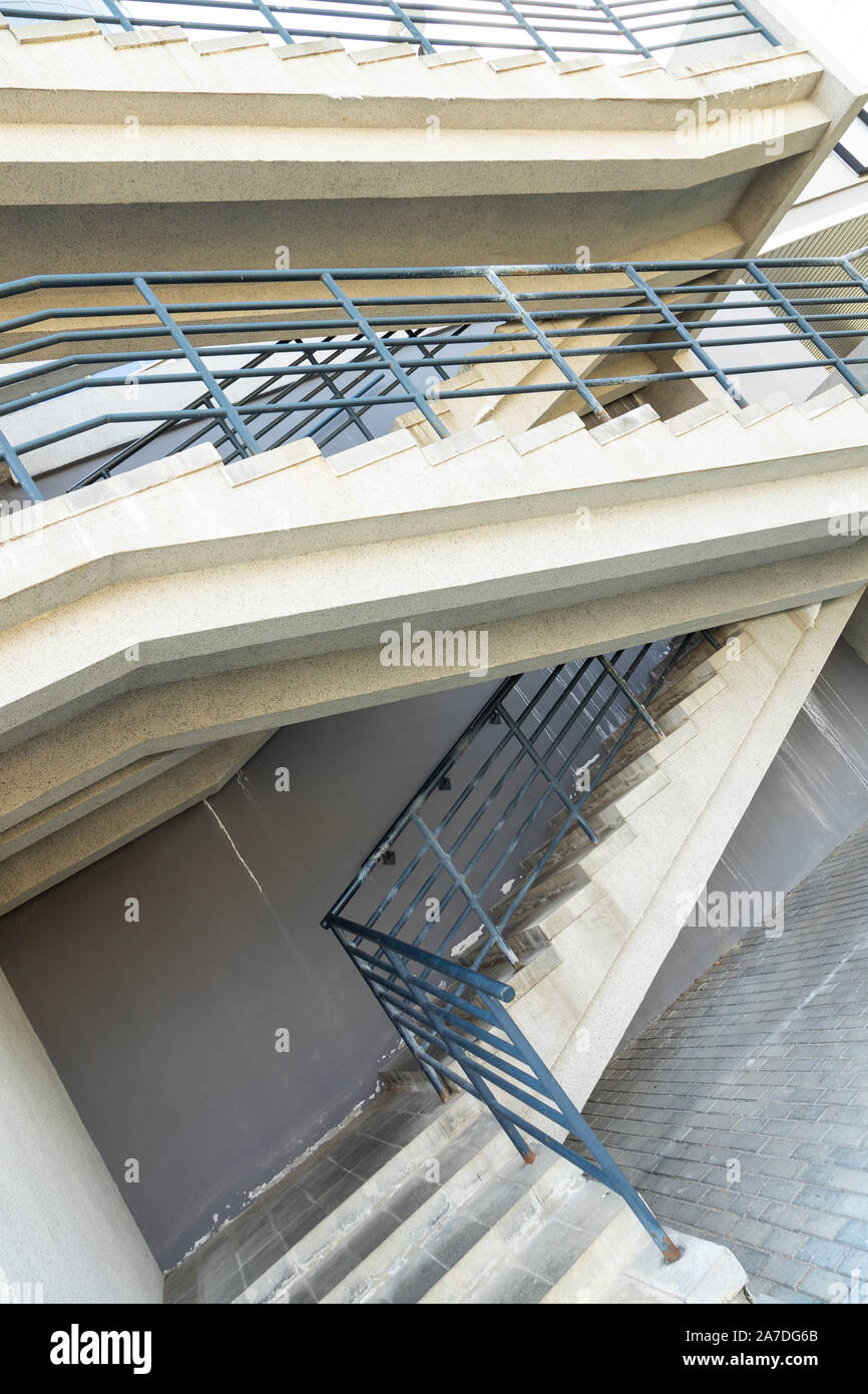 Ground diagonal view of high white cement stairs to building ...