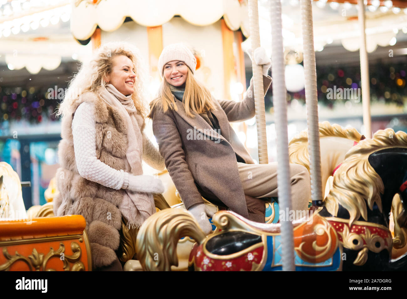 Women riding on carousel hi-res stock photography and images - Alamy