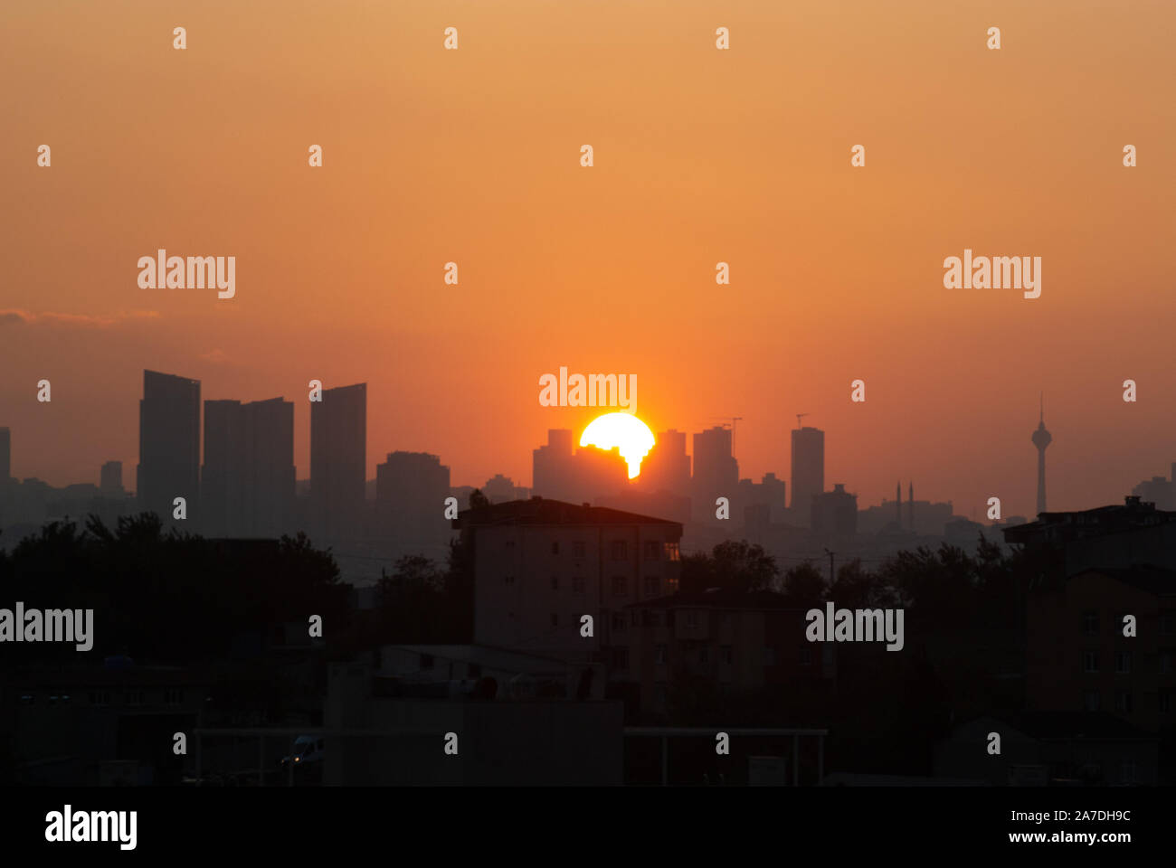 sunset over big city, red colours in the sky with cityscape Stock Photo ...