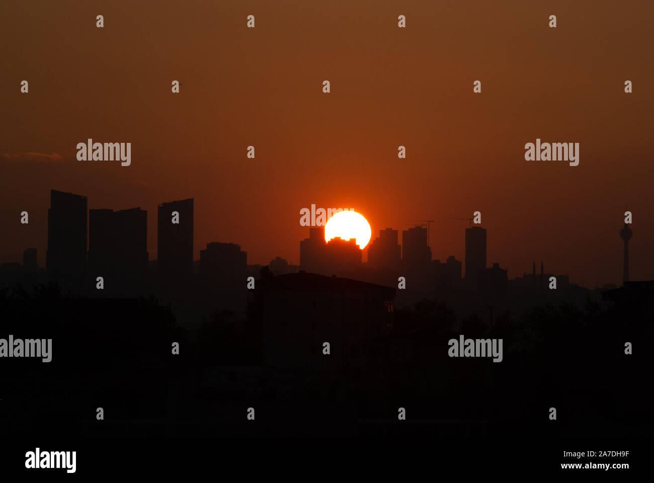 sunset over big city, red colours in the sky with cityscape Stock Photo ...