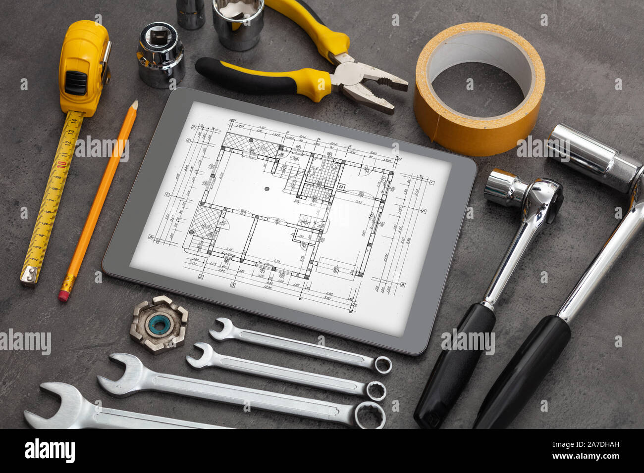 Tablet with construction tools and blueprint concept Stock Photo - Alamy