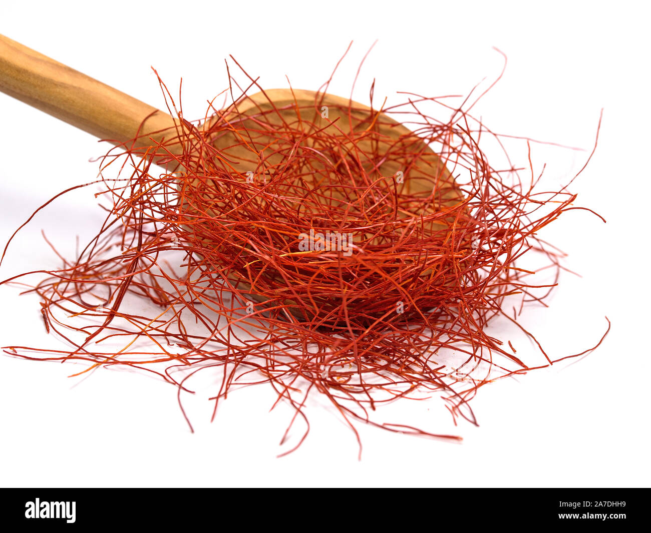 Chili threads on a wooden spoon in front of white background Stock ...