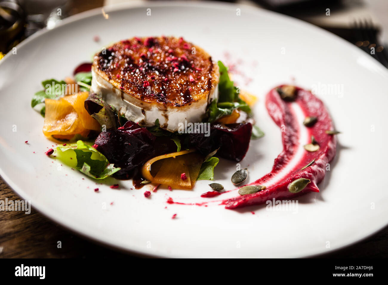 Grilled goat cheese salad served on a plate in restaurant Stock Photo ...