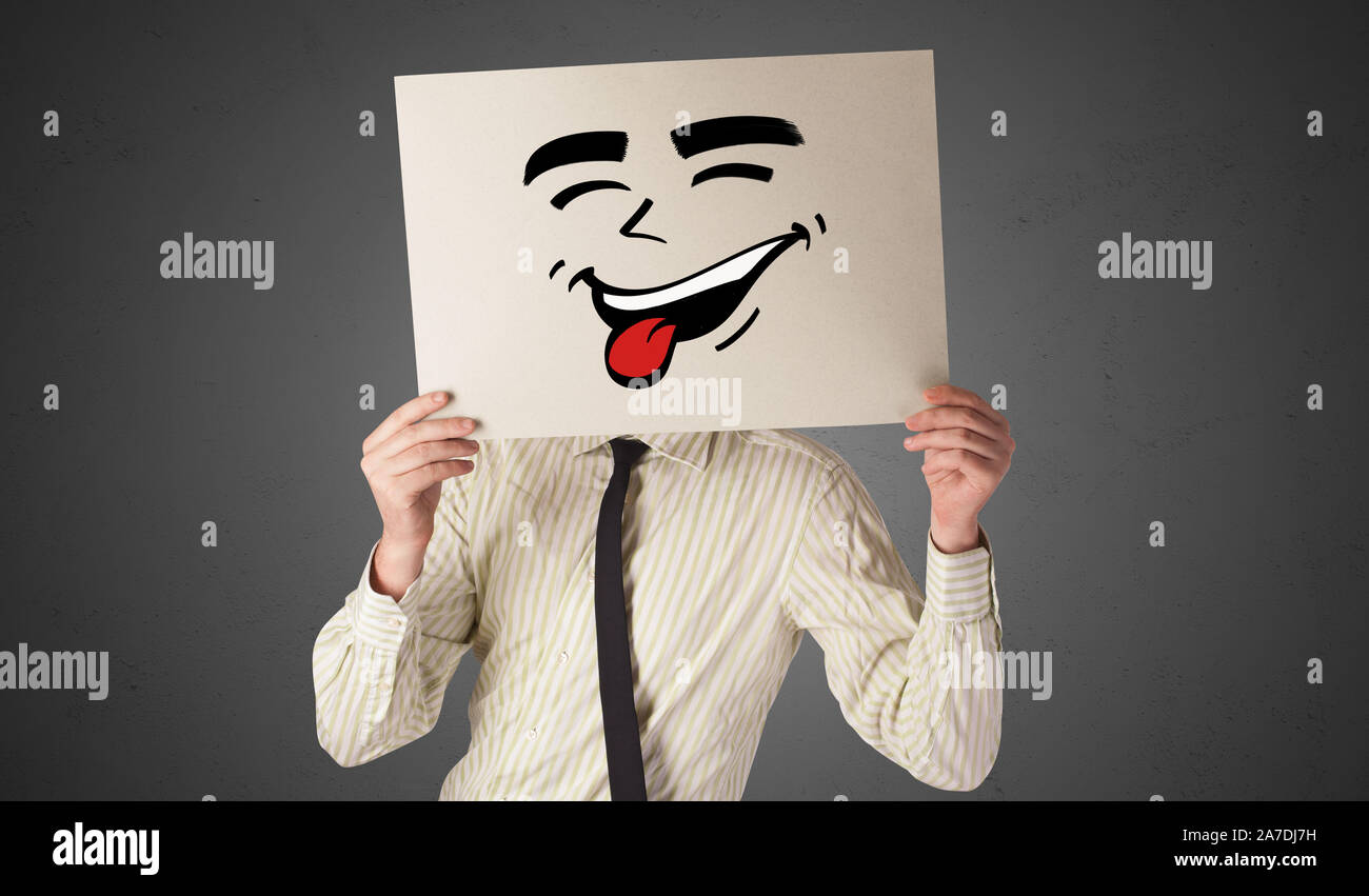 Casual person holding a paper with cool emoticon in front of his face ...