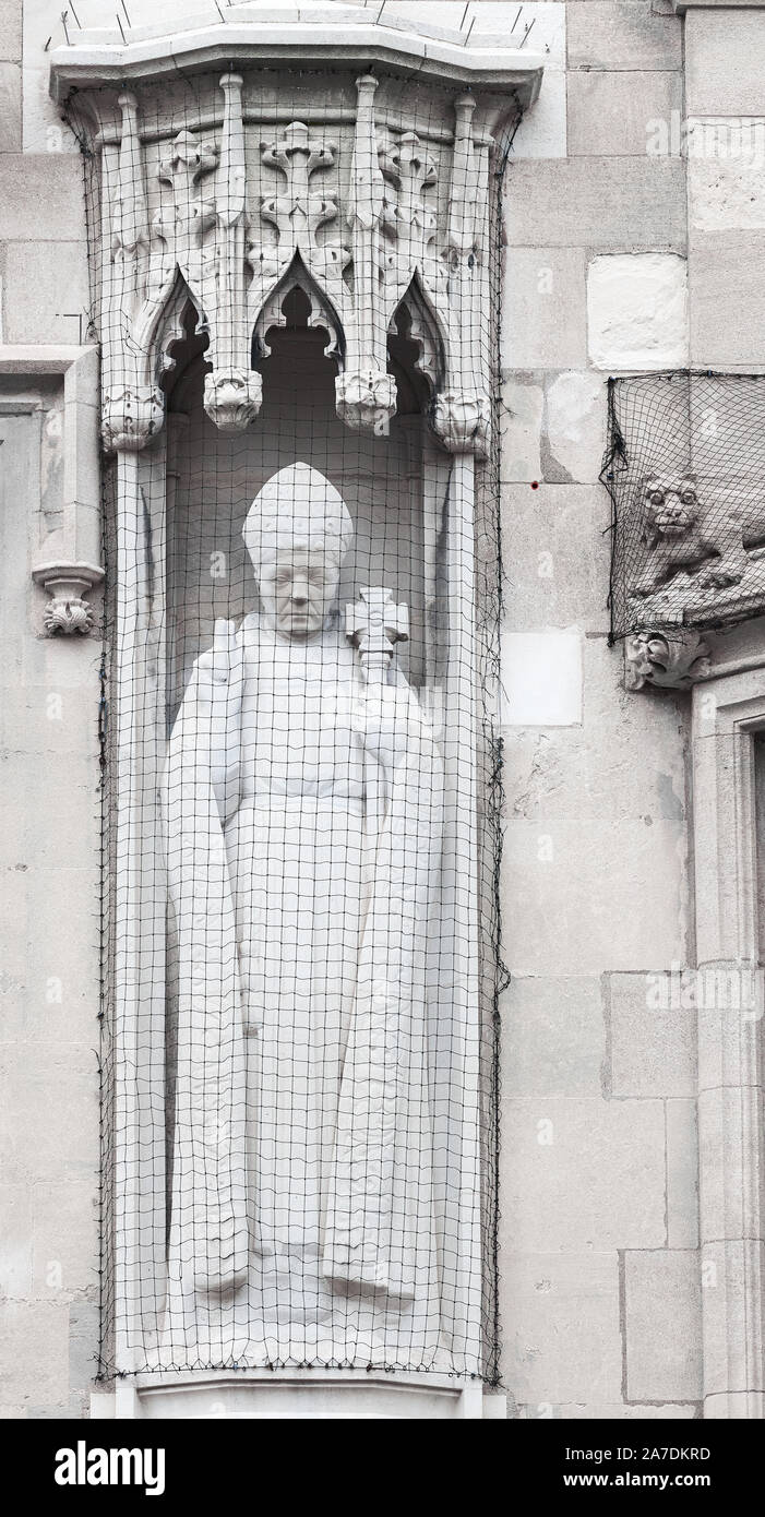On an outside wall, a statue of Archbishop Chichele, founder in the ...