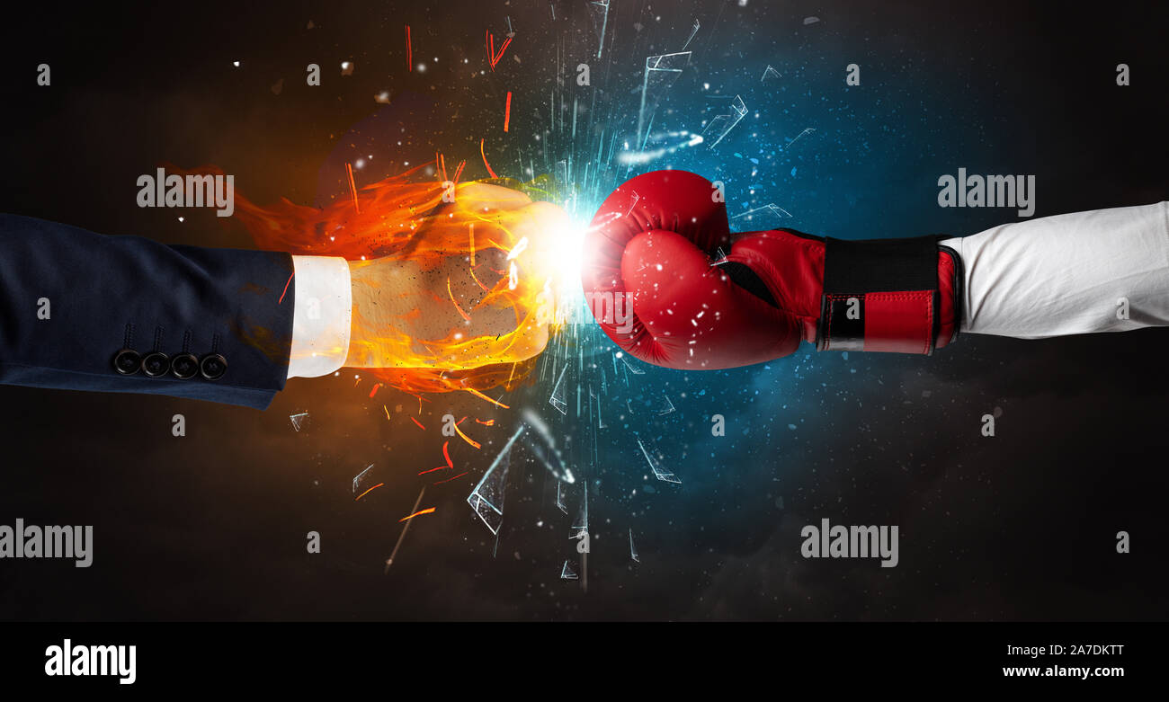 Two hands fighting and breaking glass into small pieces with fire and ...