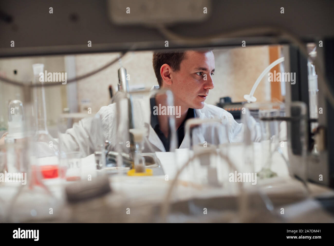 male scientist conducts chemical experiments with fluids in medical ...