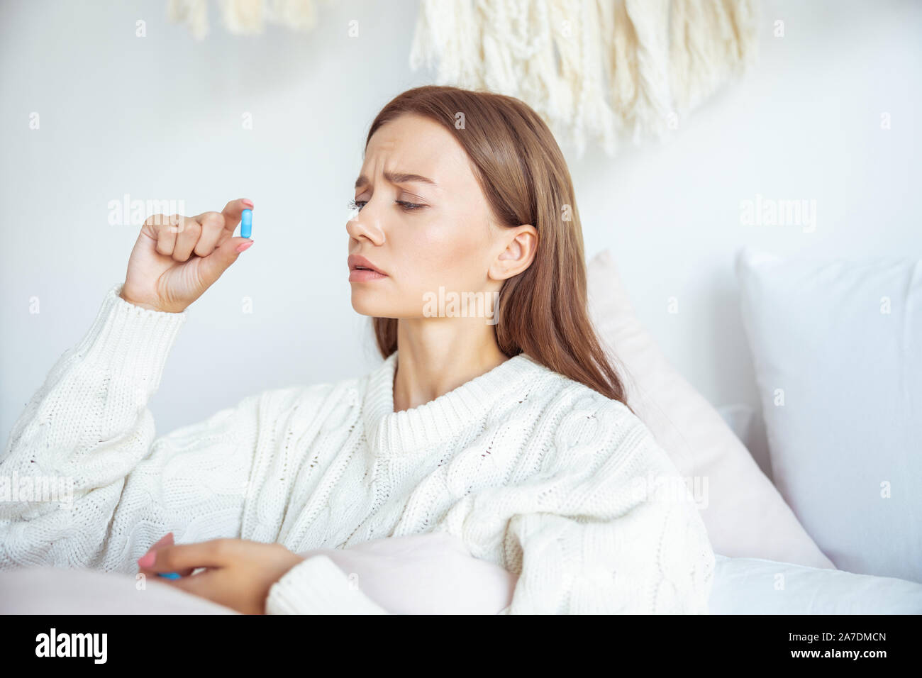 Concentrated brunette girl staring at blue tablet Stock Photo - Alamy