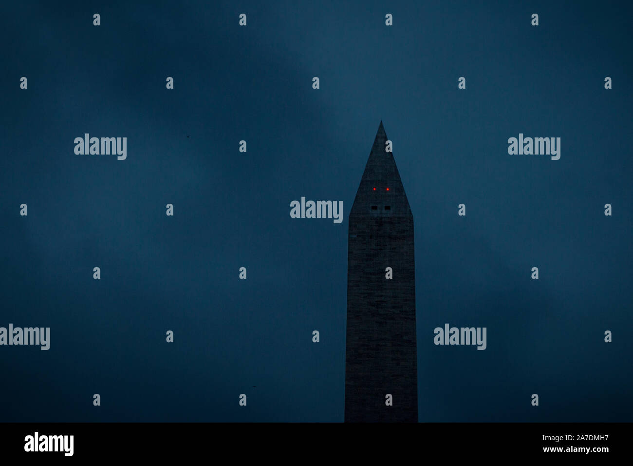 Two red lights shine from the top of the Washington Monument as two red ...