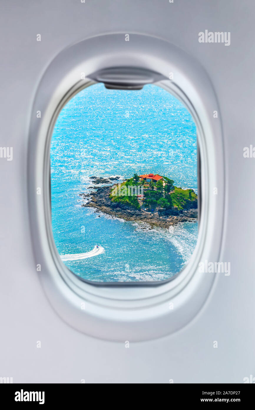 Plane window view at a tropical island in the ocean. Hon Ba, Vung Tau ...