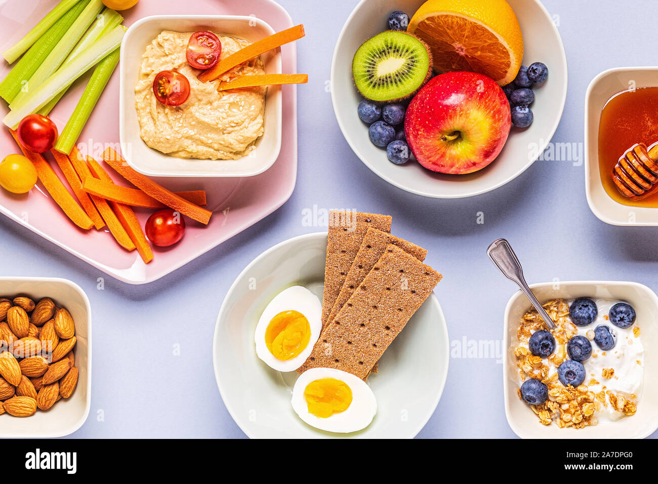 Healthy snack on a pastel background, top view Stock Photo - Alamy