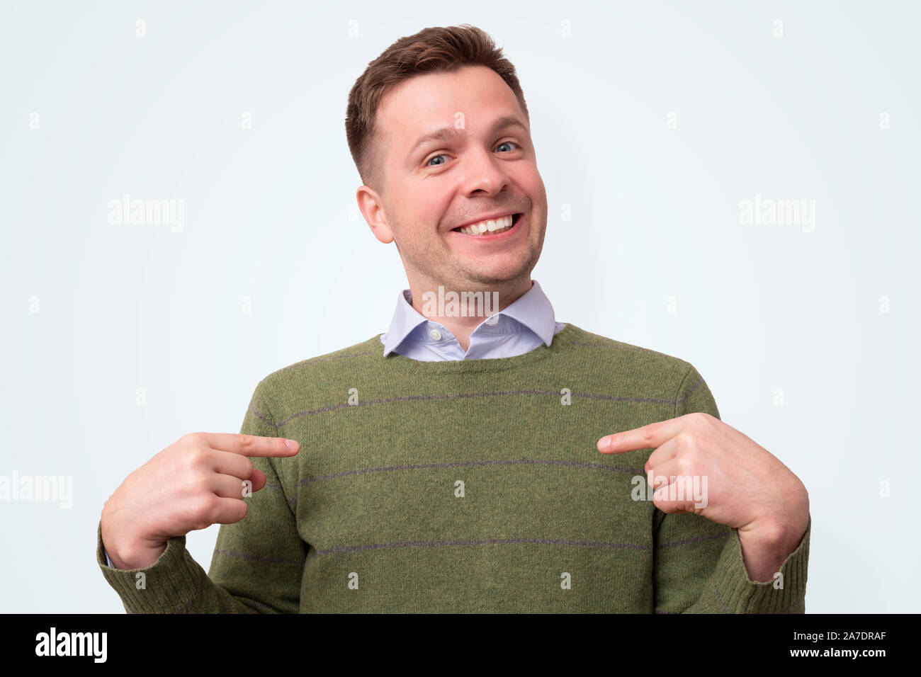 Self-satisfied and proud young man haughtily looks forward pointing ...