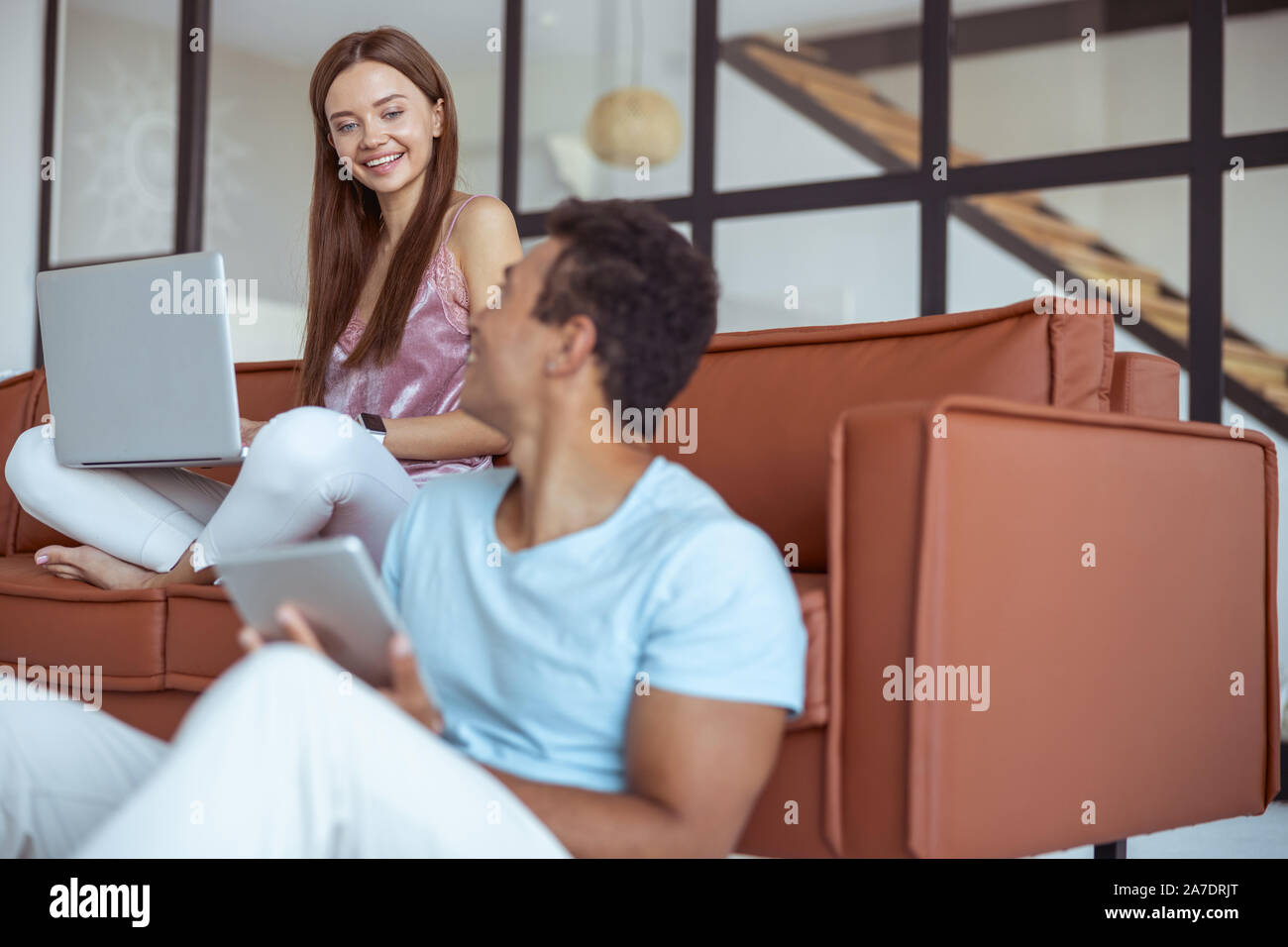 Joyful young people having pleasant conversation together Stock Photo ...