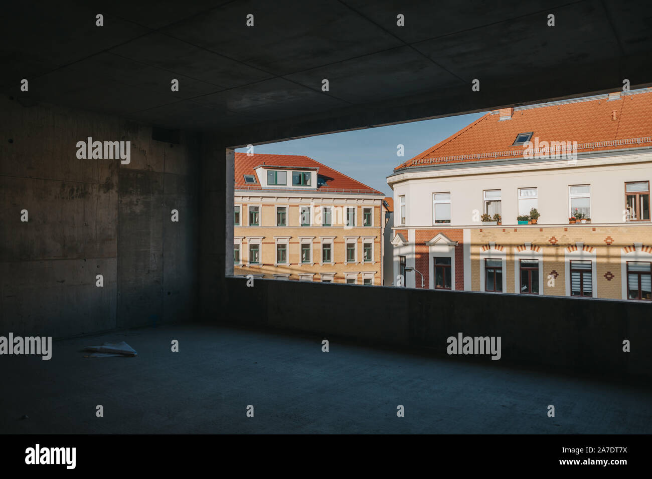 view out of a huge window at a construction site towards a residential ...
