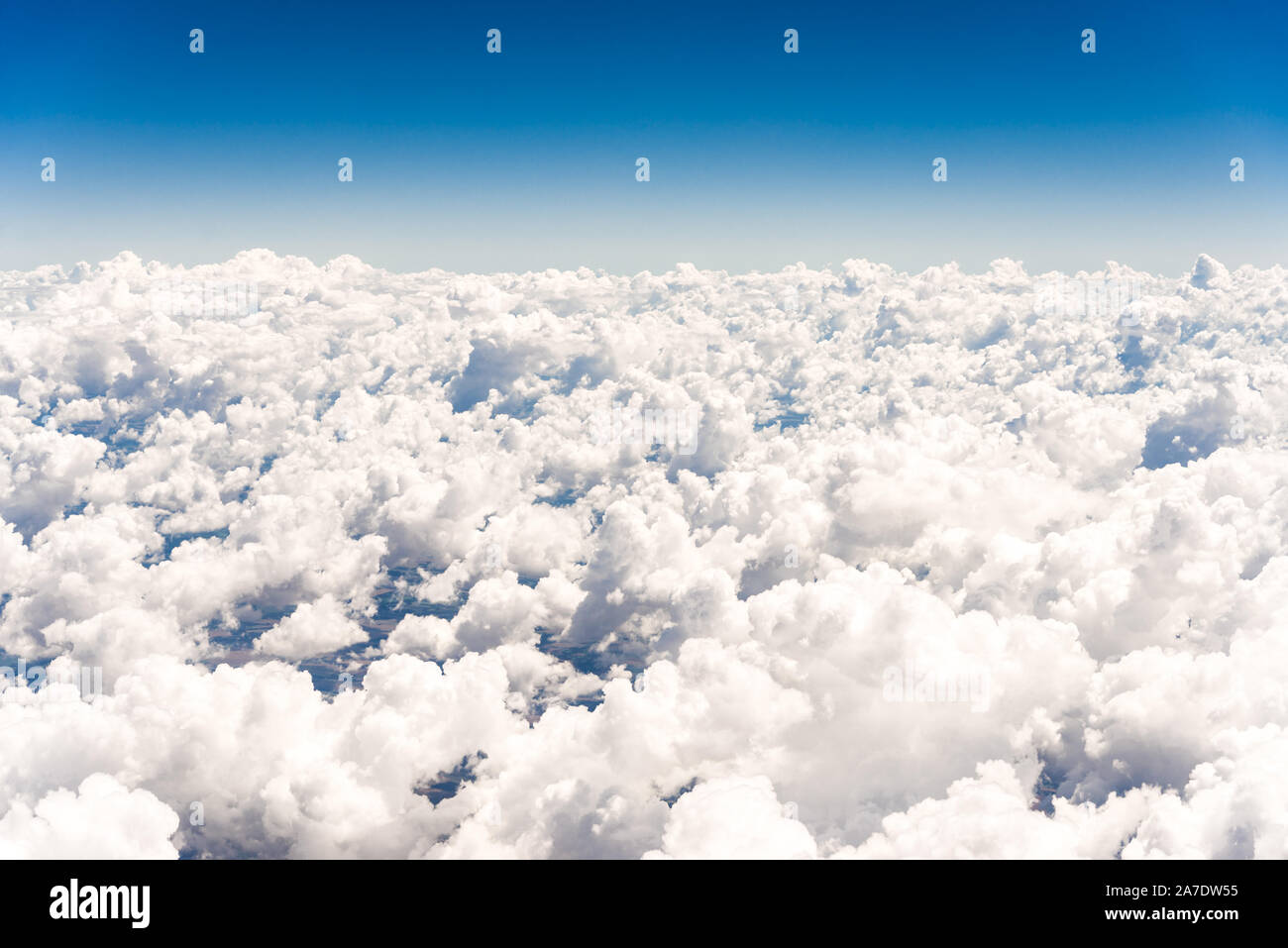 Abstract skyscape background with white cumulus clouds against blue sky ...