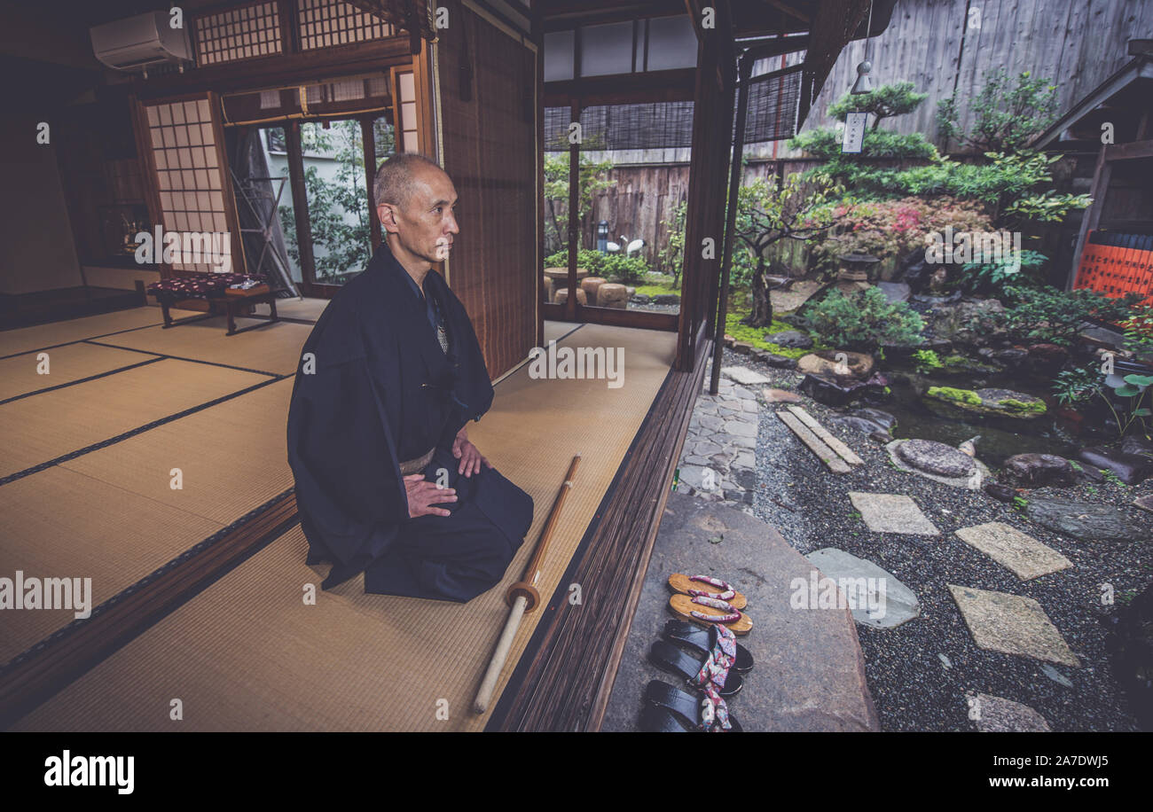 Japanese man meditating in his garden Stock Photo - Alamy