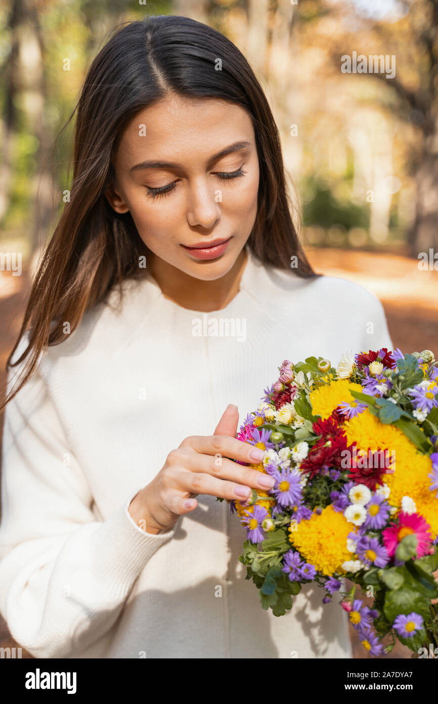 Woman touching flowers walking in hi-res stock photography and images ...