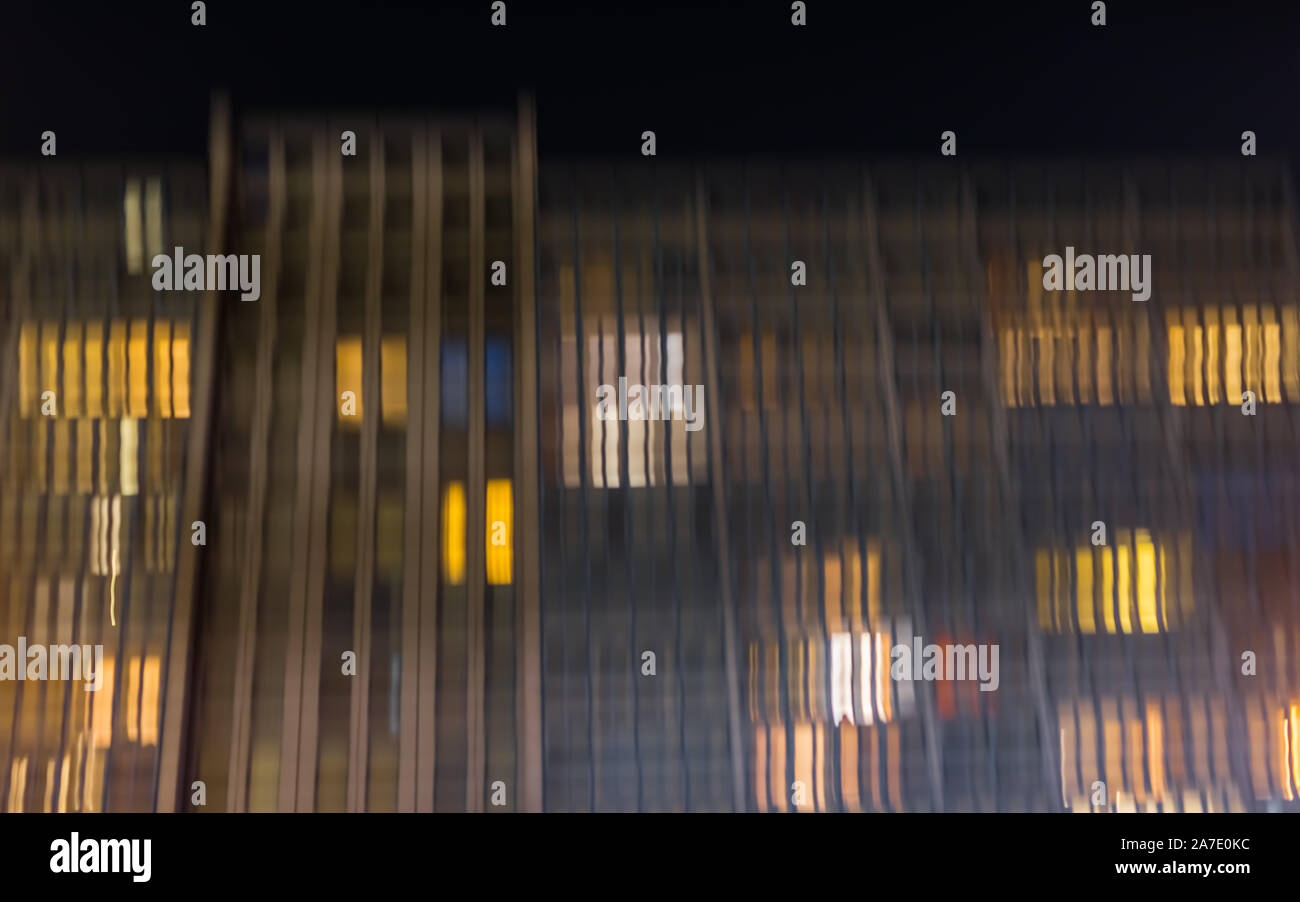A colorful facade of an apartment building at night Stock Photo - Alamy
