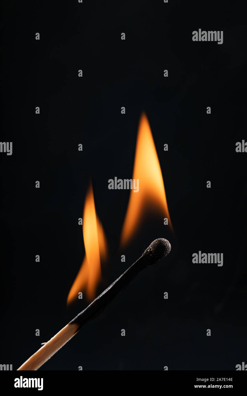 Flame on a small match. Glowing match in flames. dark background Stock ...