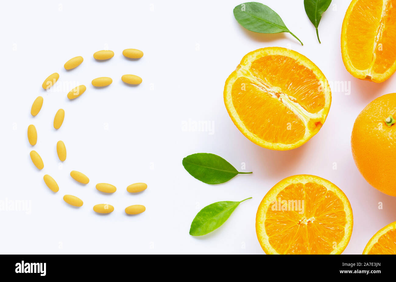 Vitamin C pills with fresh orange citrus fruit isolated on white ...
