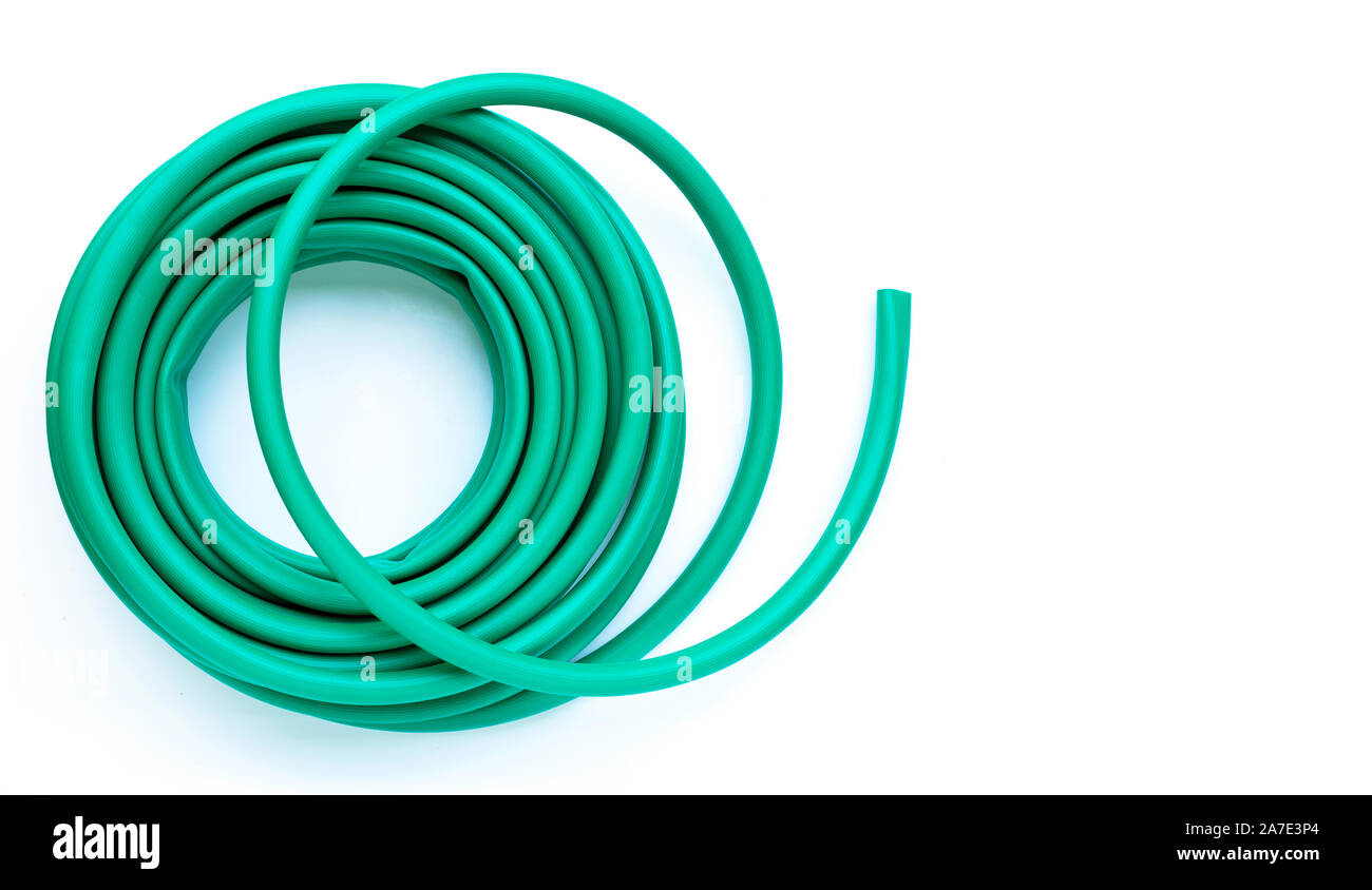 Green garden hose on white background. Copy space Stock Photo - Alamy