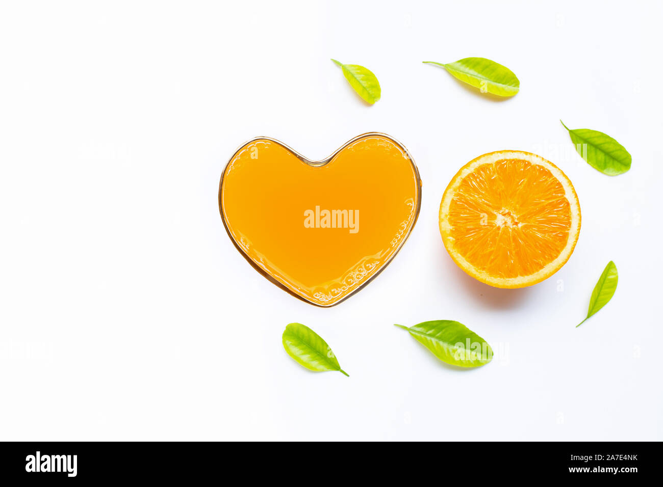 Heart shape glass of fresh orange juice with orange fruit on white ...