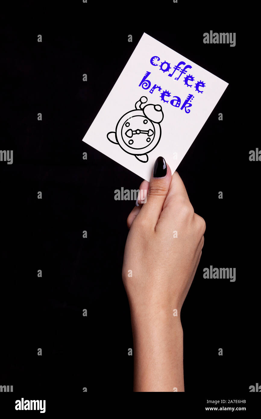 hand holding coffee break card on black background Stock Photo - Alamy
