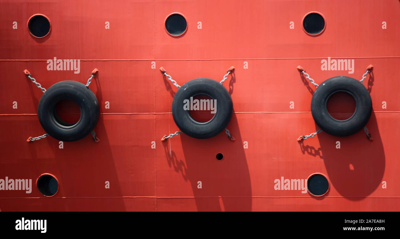 Rubber wheel on the boat to prevent collisions. The ship is painted red ...
