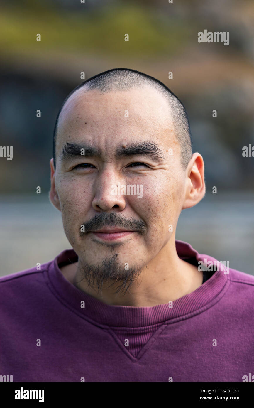 Portrait of a local inuit young man looking camera in Sisimiut ...