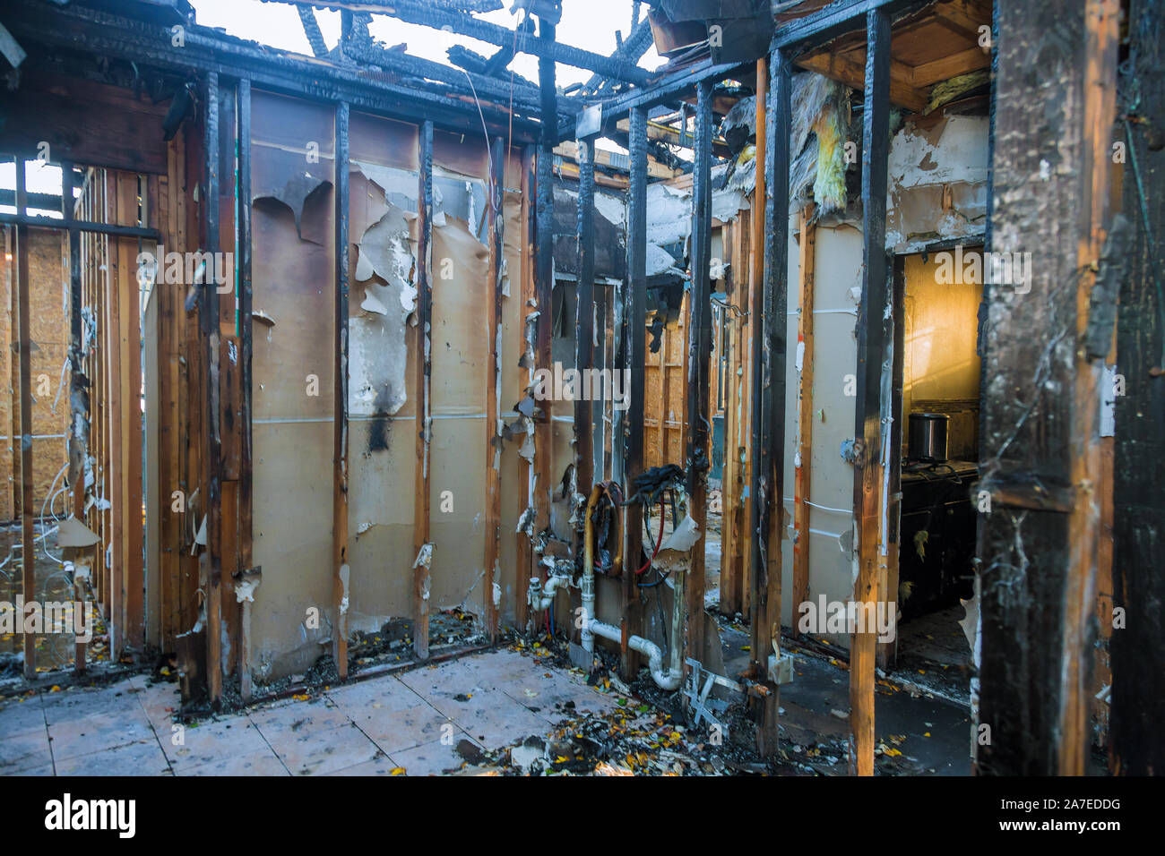 Burnt wooden walls house with charred roof burnt fire damaged interior ...