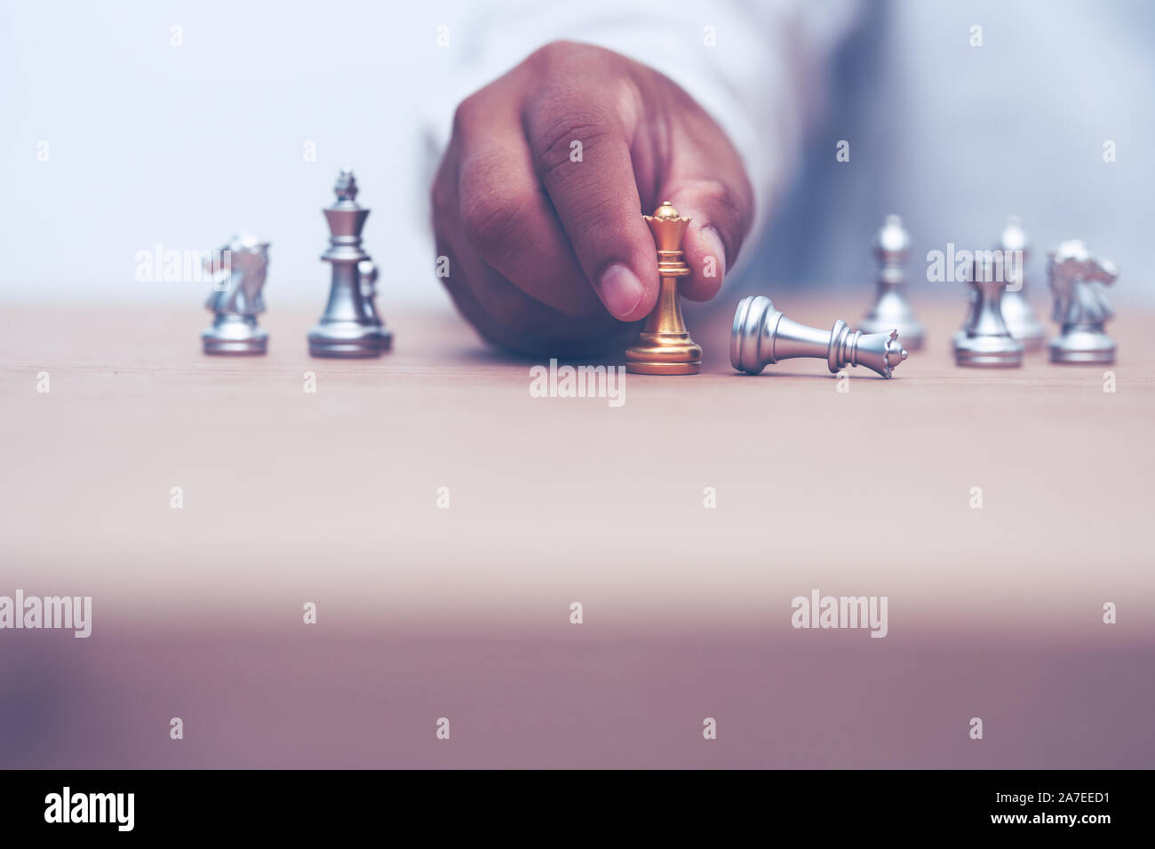 businessman holding and moving chess figure in competition success ...