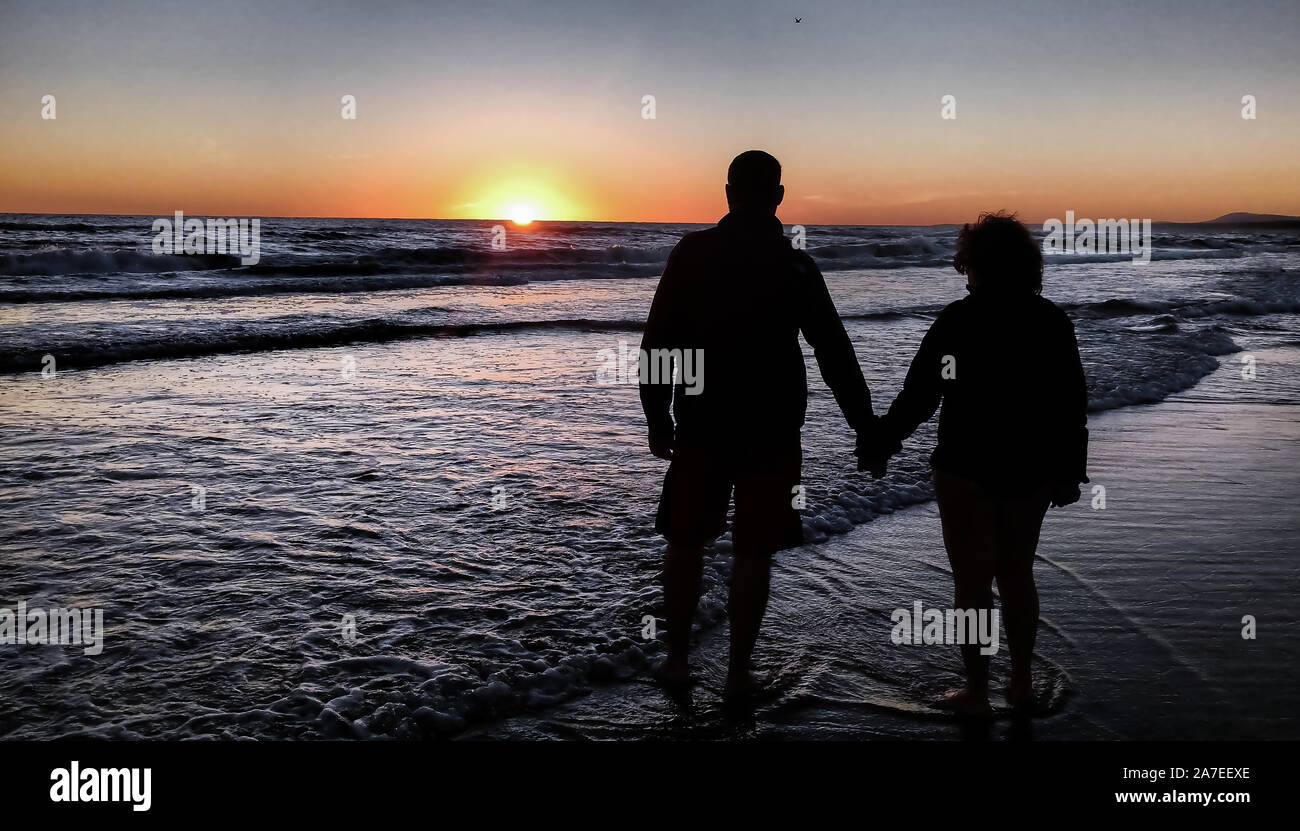 an old couple enjoying a lovely sunset at the beach Stock Photo - Alamy
