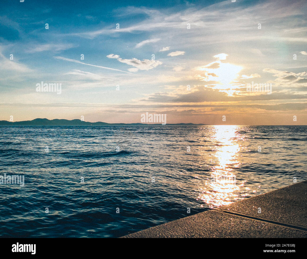 a view of a stunning sunset from the sea organ at the coastline of ...