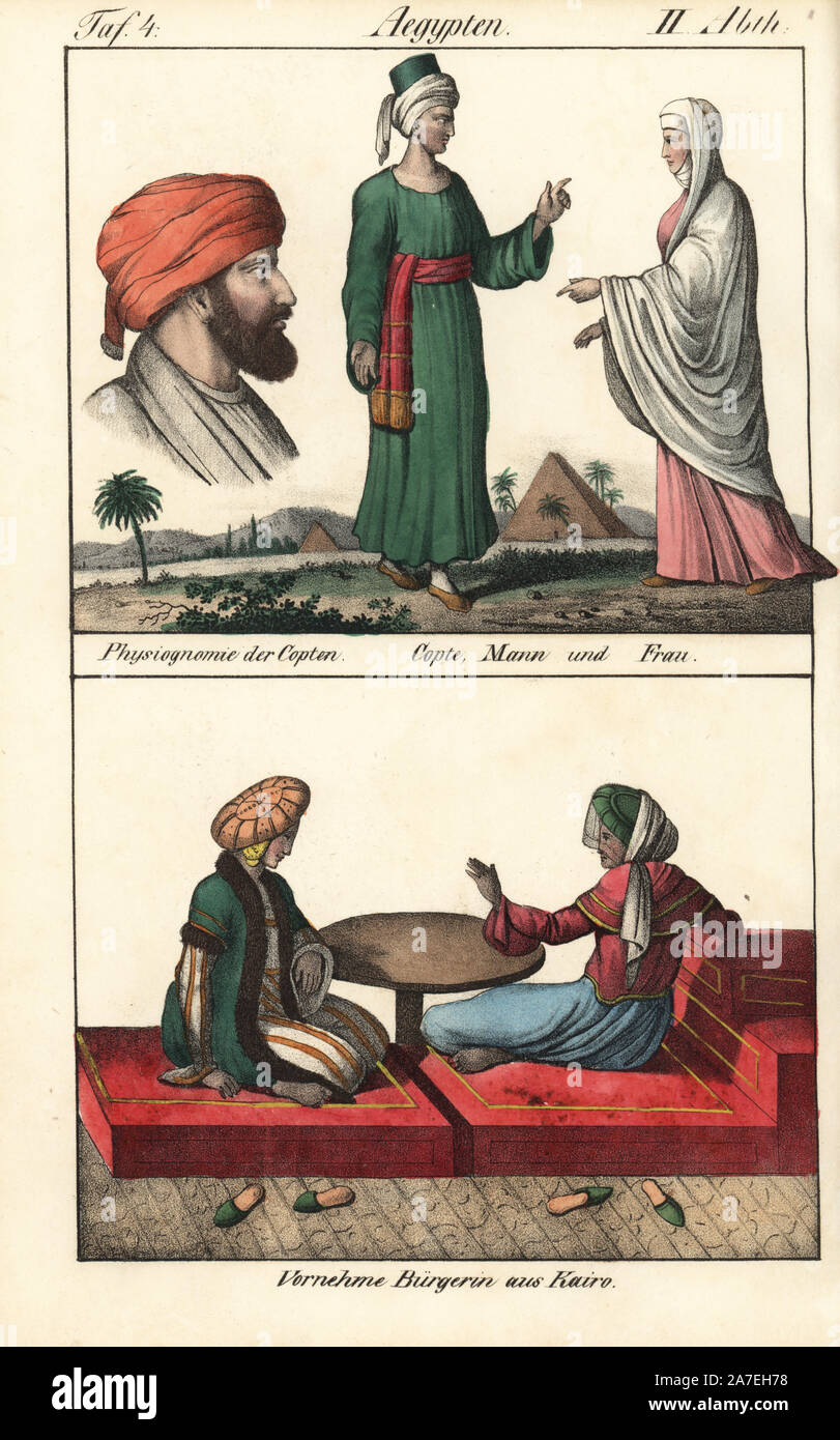 Coptic man and woman in robes, veil and turban in front of the pyramids ...