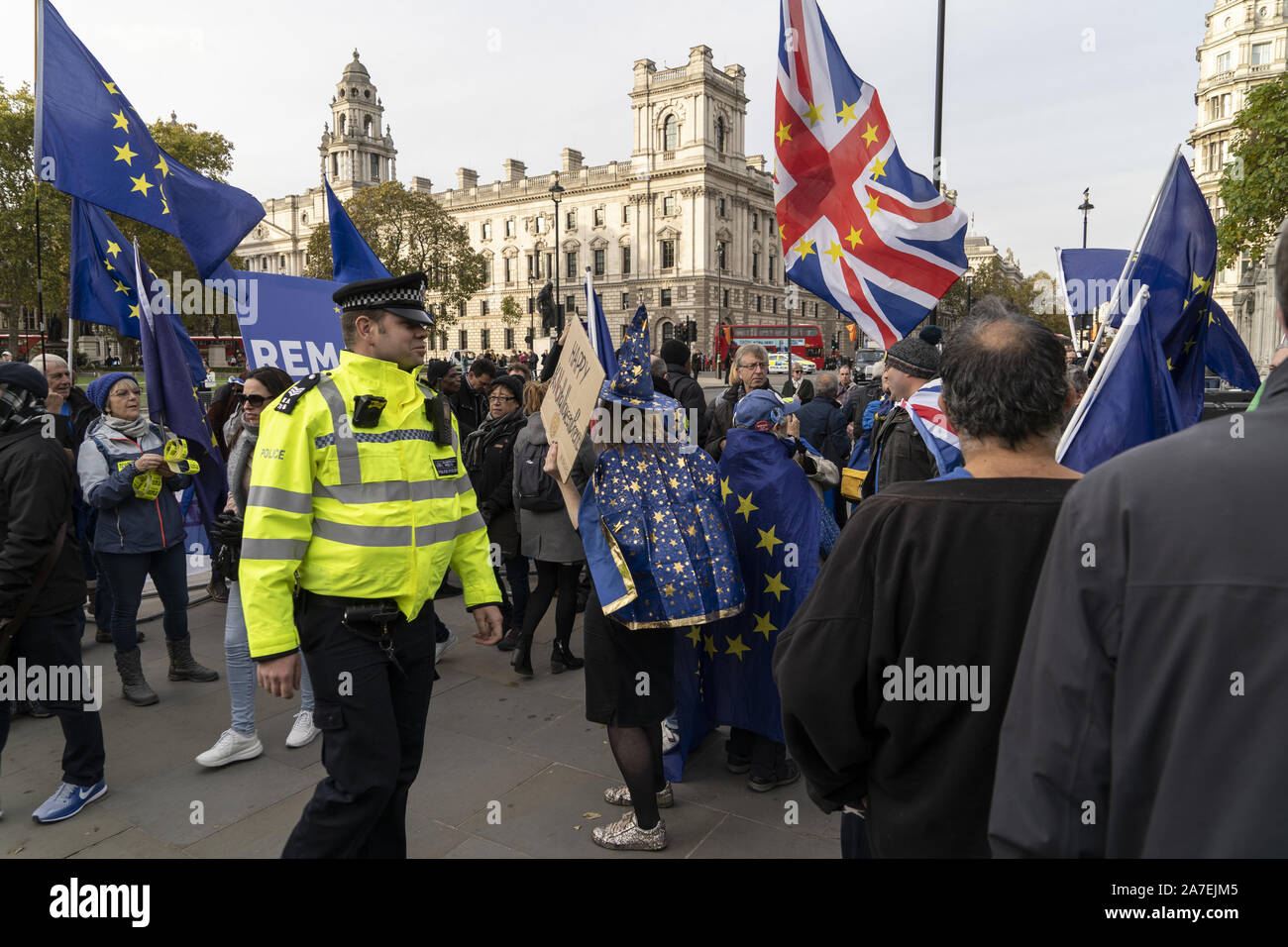 London, UK. 30th Oct, 2019. A police man walks through protesters ...