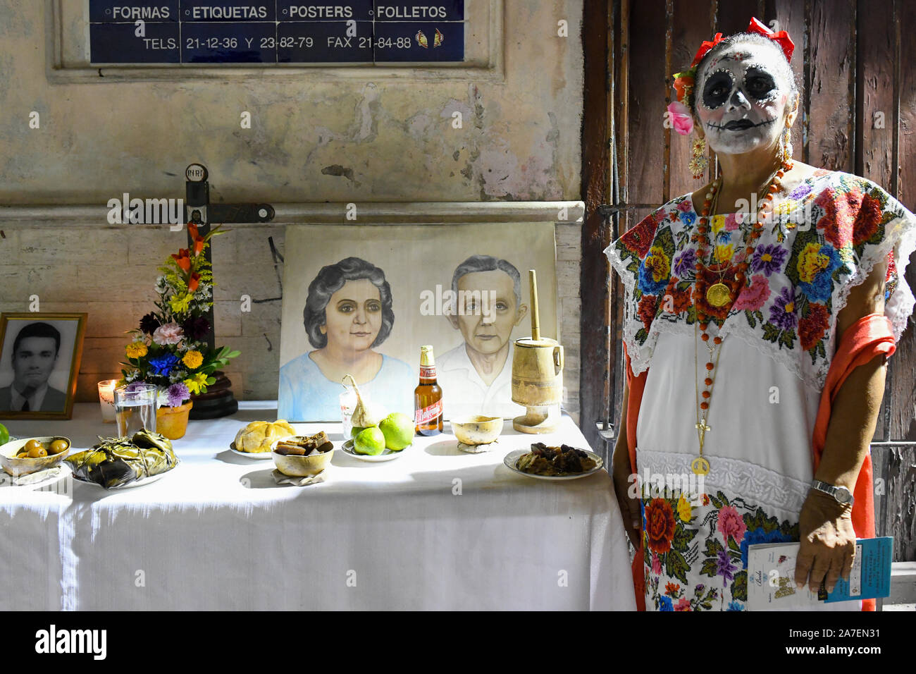 Merida woman in front of her family altar during Hanal Pixan which is ...