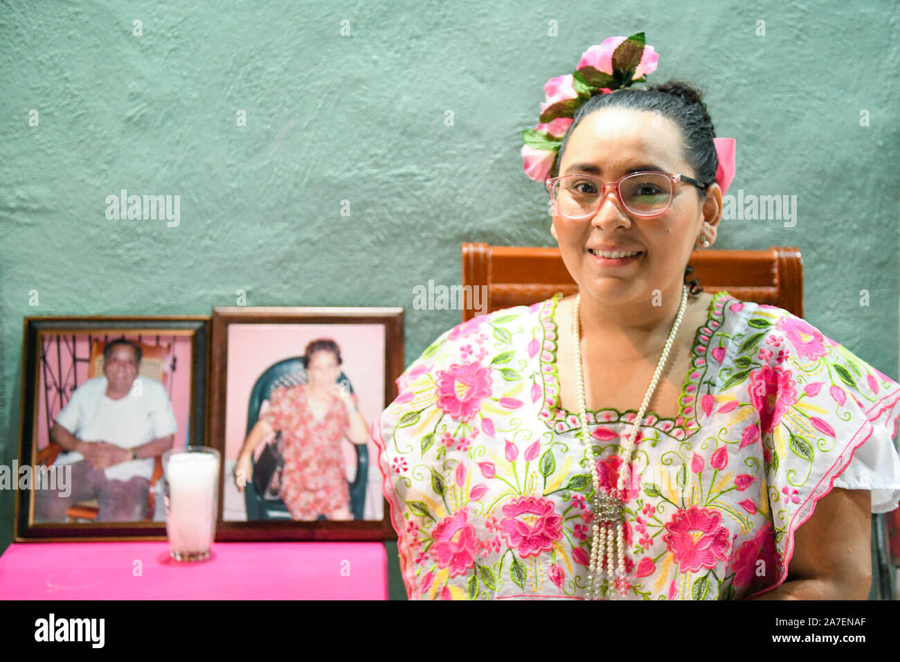 Merida woman in front of her family altar during Hanal Pixan which is ...