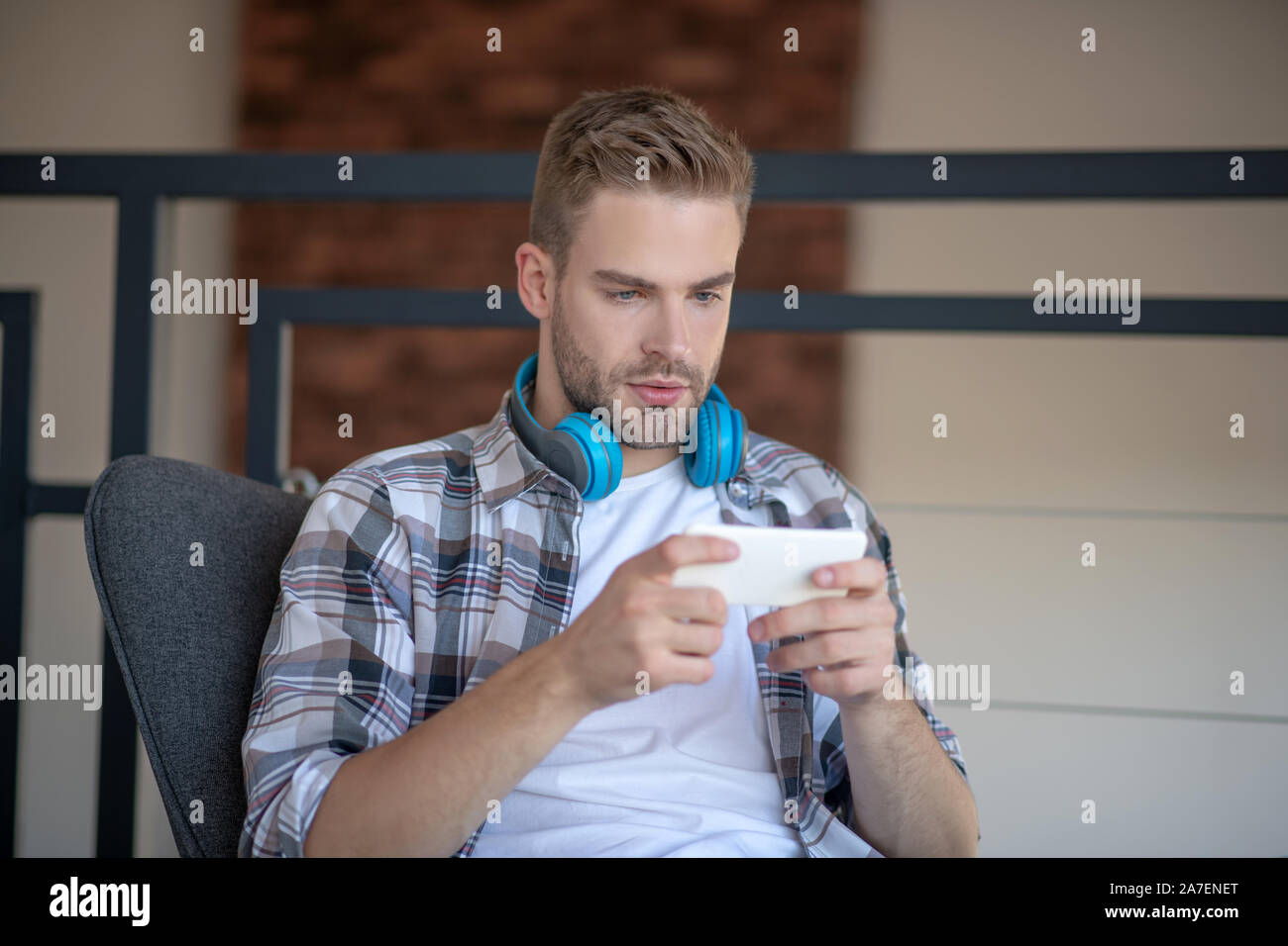 Bearded man playing video game on smartphone Stock Photo - Alamy